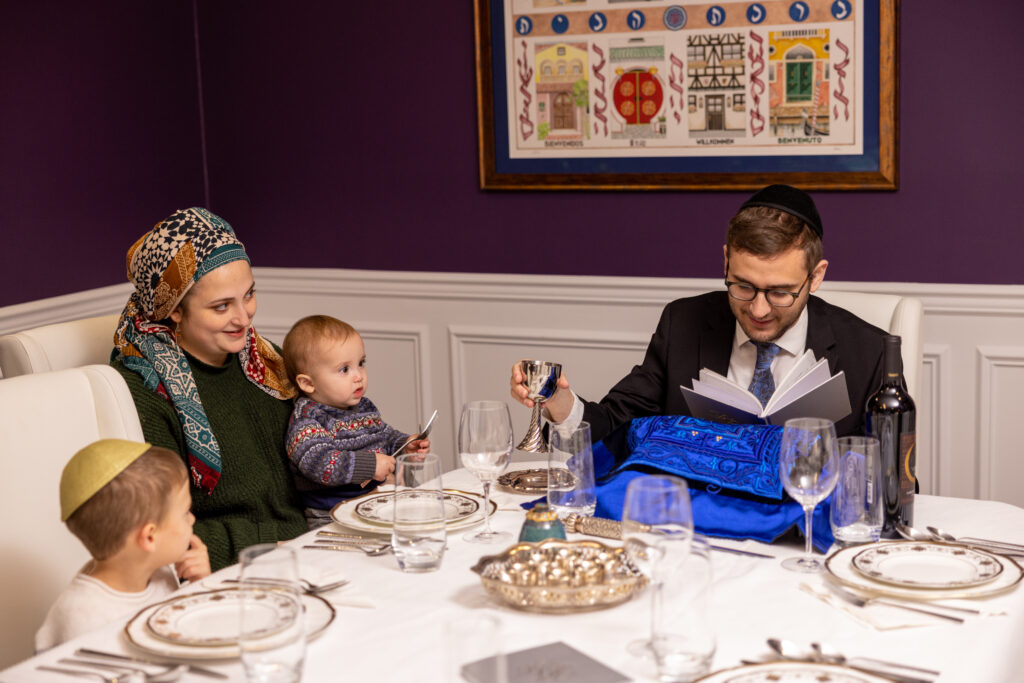 Father sitting making kiddush with family – The Jewish Life Photo Bank